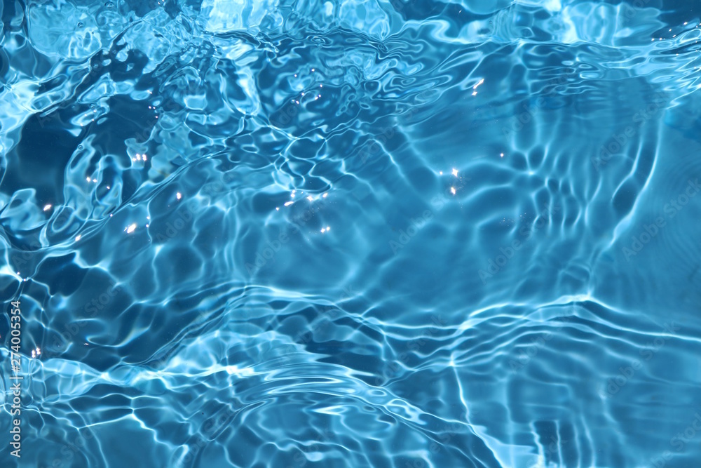 Blue and bright water surface with sun refection in swimming pool for ...