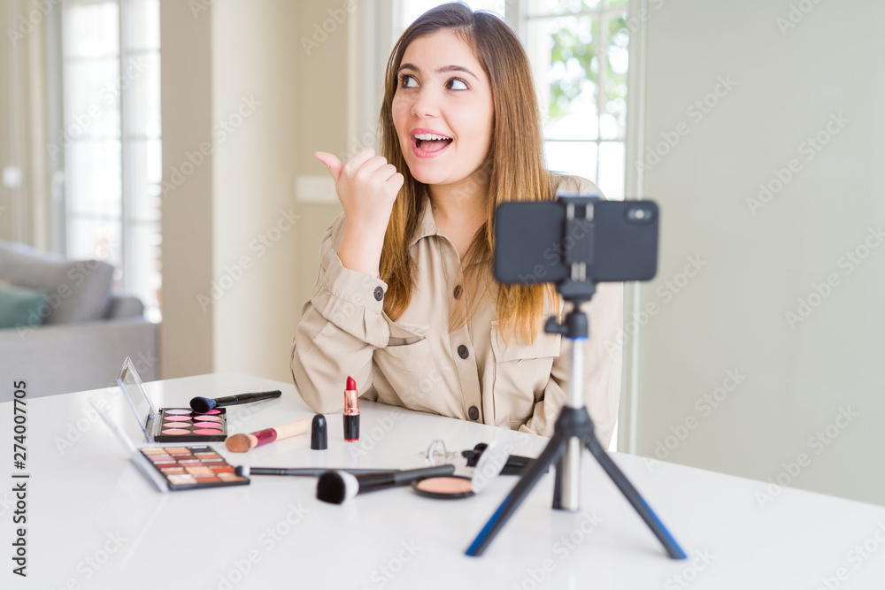 Beautiful young influencer woman recording make up video tutorial ...