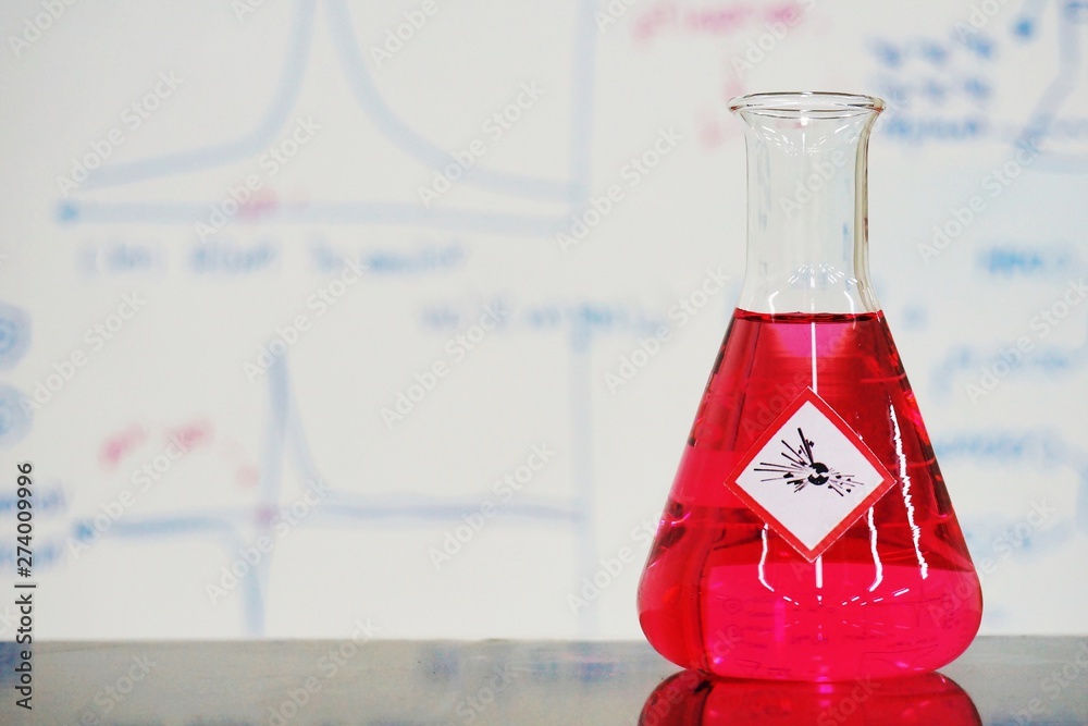 Erlenmeyer flask with Pink liquid and chemical hazard warning symbols ...