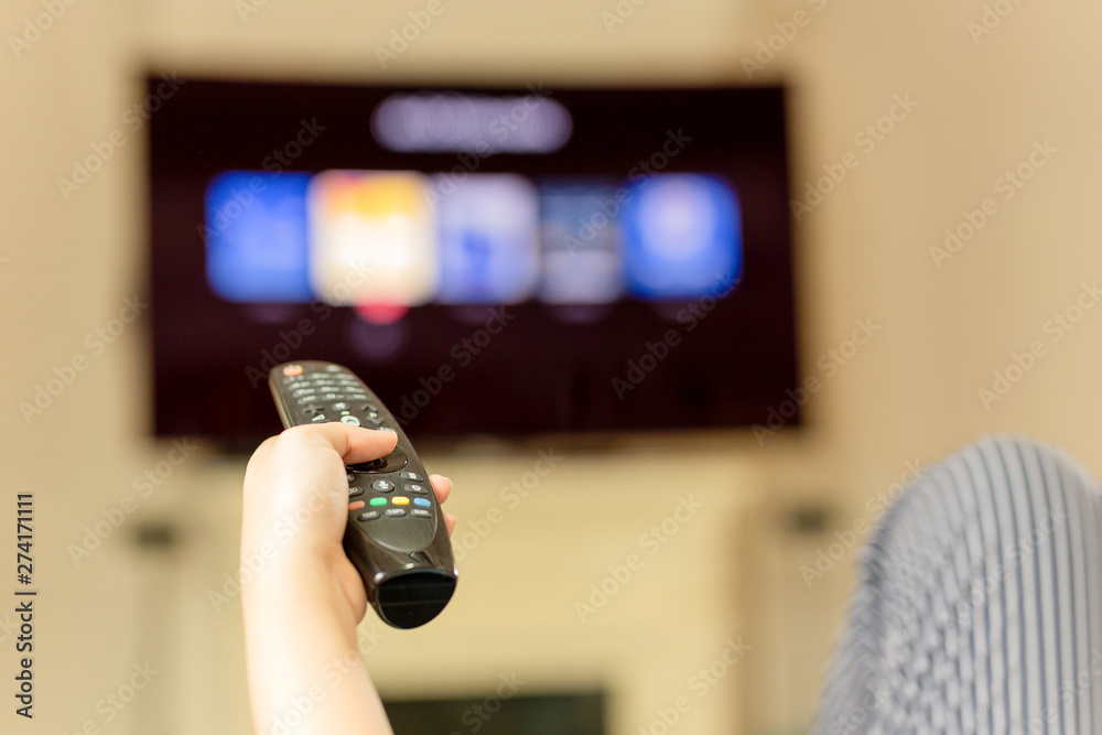 Hand using remote controller for watching television at home. Stock ...