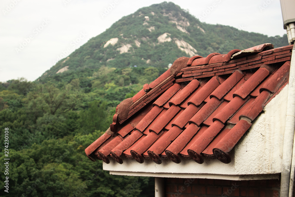 The image of faded roof tiles of old house in oriental style, Bukchon ...