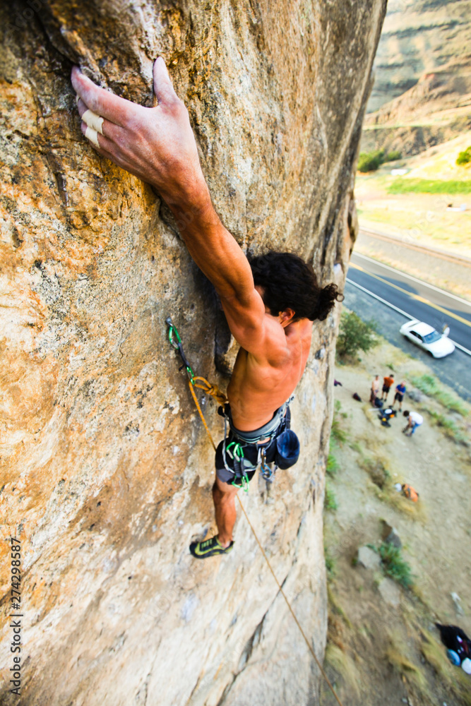 A man climbs Hand Over Hand 5.11a at Granite Point, a small climbing ...