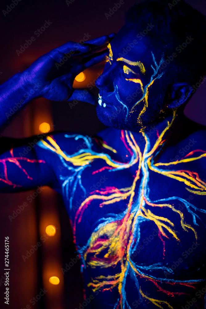 UV patterns body art of the circulatory system on a man's body. On the ...