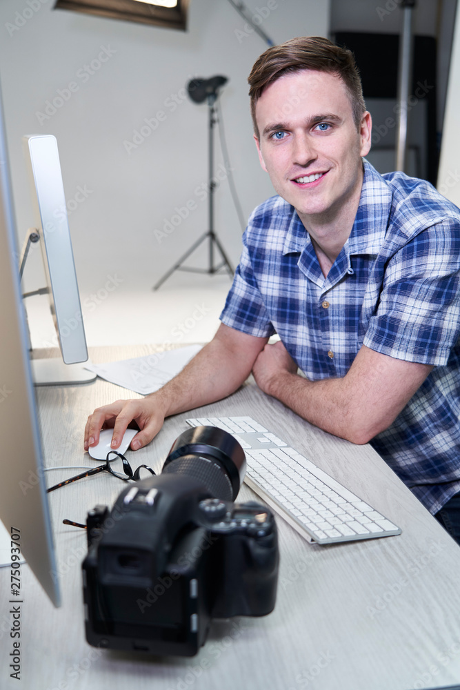 Portrait Of Male Photographer In Studio Reviewing Images From Photo ...