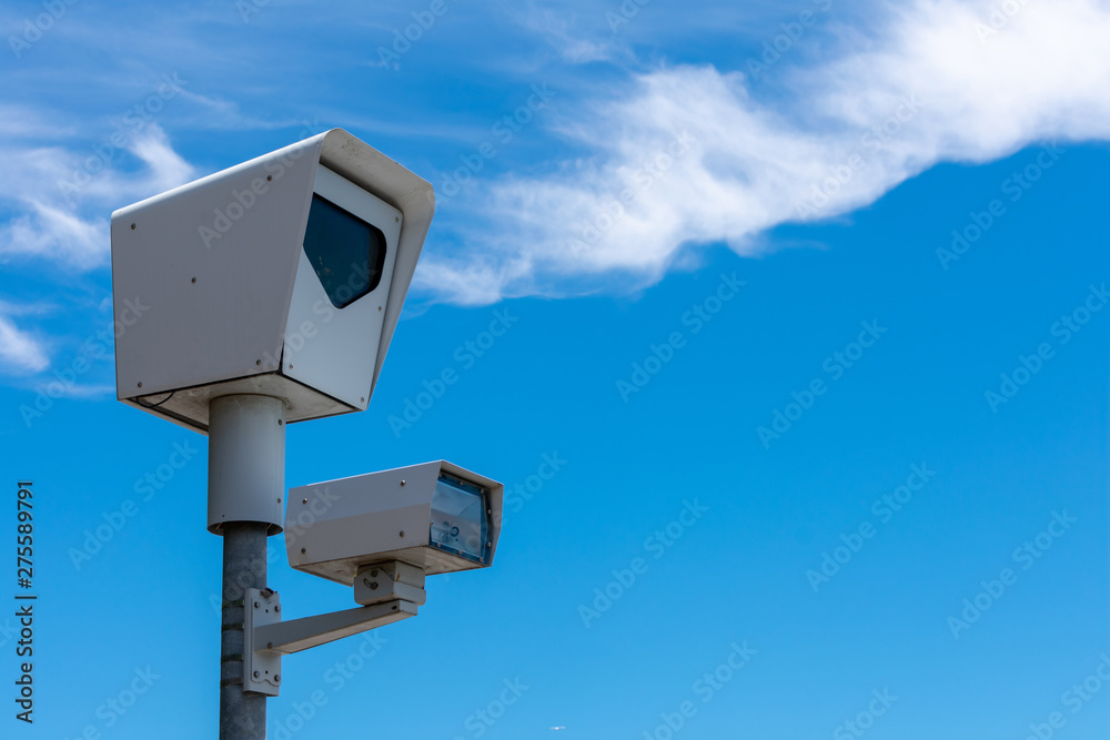 Red light camera. Close up. Traffic enforcement camera. Background blue ...