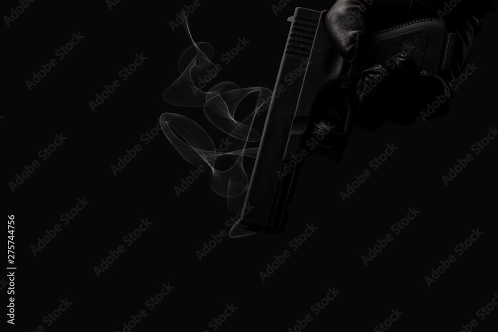 The smoking gun and hired assassin concept with a murderer hand wearing ...