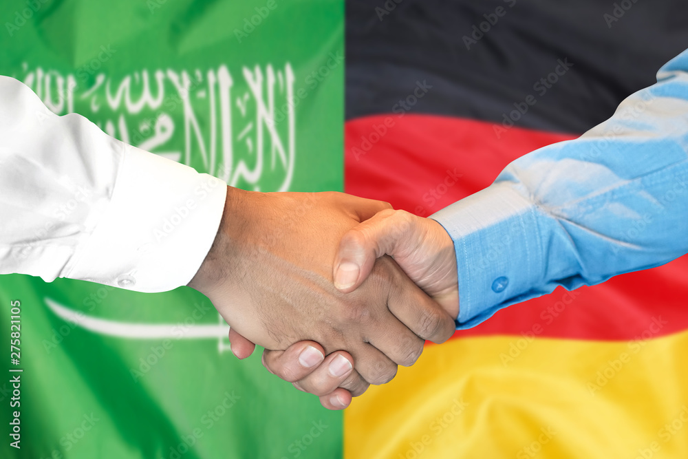 Business handshake on the background of two flags. Men handshake on the ...