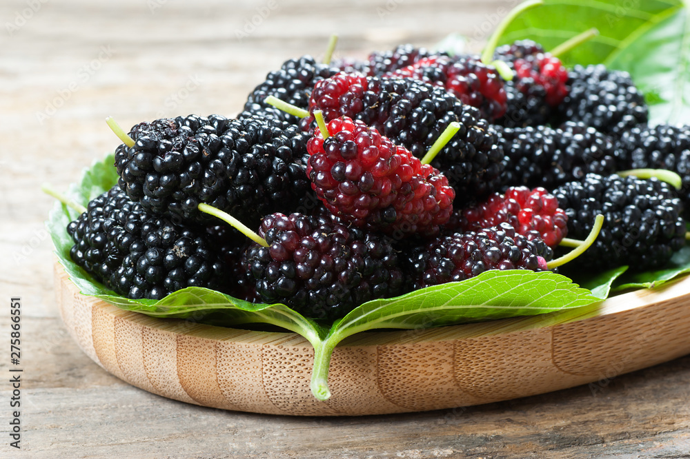 Fresh ripe black mulberry berry fruit with leaf on rustic wooden ... Fresh ripe black mulberry berry fruit with leaf on rustic wooden ...