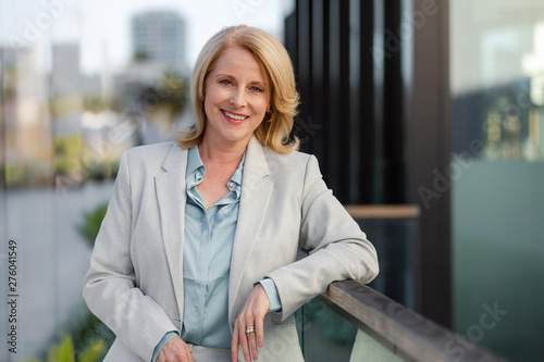 Attractive CEO older business woman executive portrait pose, standing ...