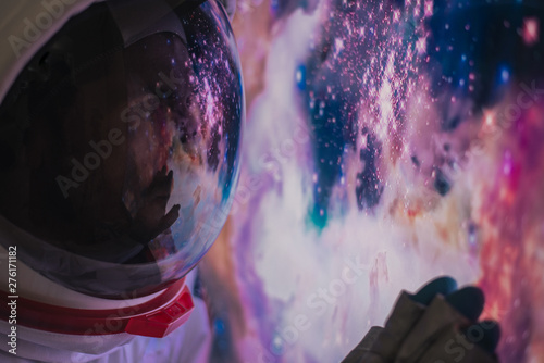 Astronaut looking deep space, galaxy and planets from the window of his ...
