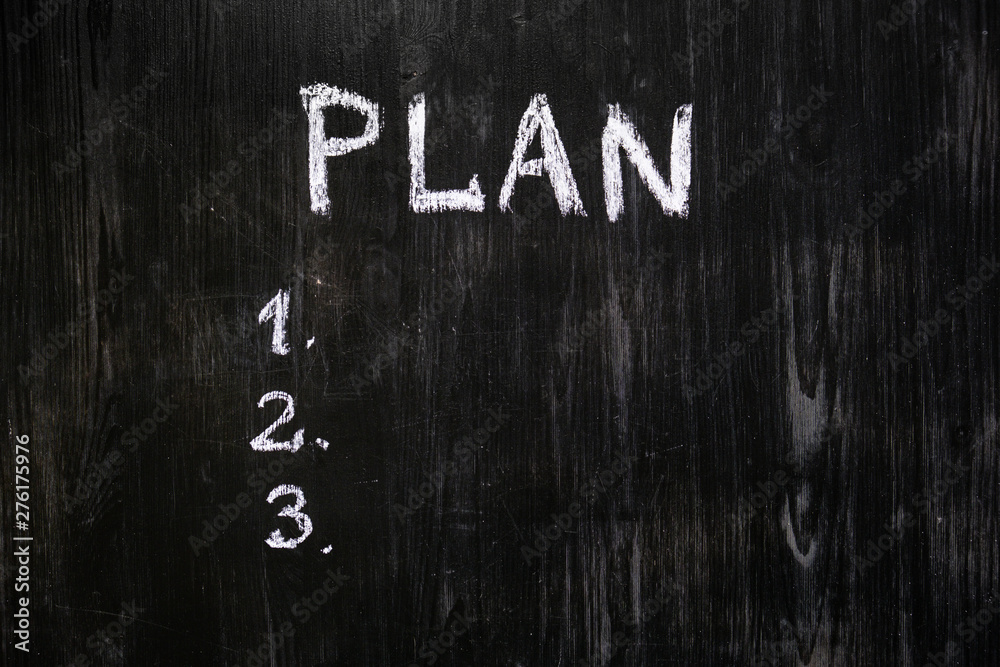 Plan list handwritten with chalk on blackboard. Black wood background ...