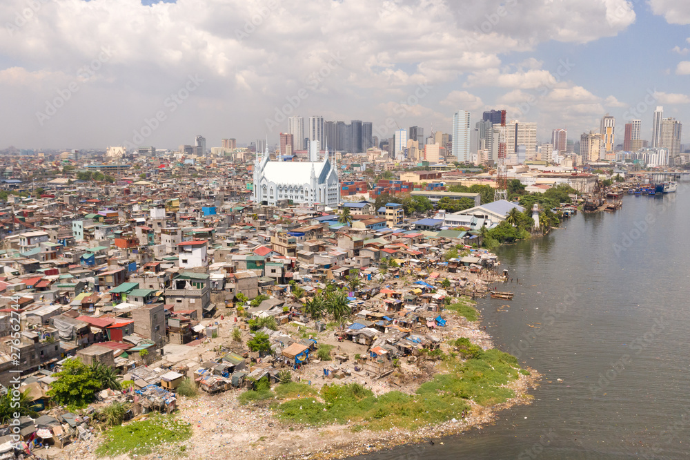 The urban landscape of Manila, with slums and skyscrapers. Sea port and ...