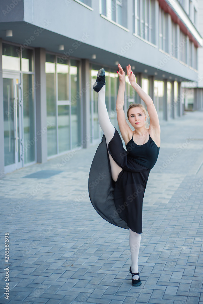 Ballerina in tutu posing against a residential building. Beautiful ...