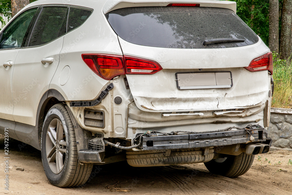 Dusty damaged car after an accident. Vehicle with removed rear bumper ...