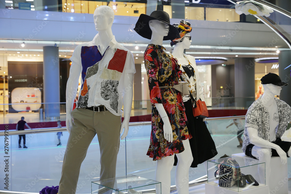 Mannequins standing in the display of a women's and mens casual ...