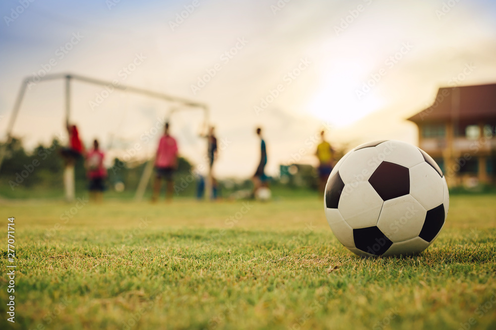 Action sport outdoors of kids having fun playing soccer football for ...