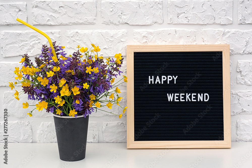 Happy weekend words on black letter board and bouquet of colored ...