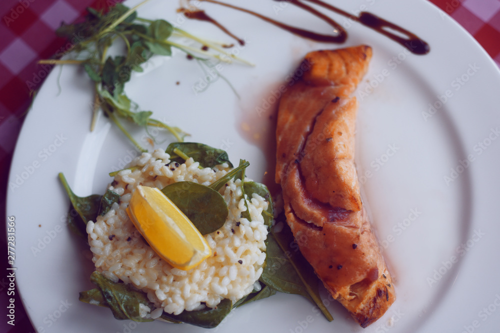 Restaurant feed. Salmon with risotto. Fish and rice Fish with lemon ...