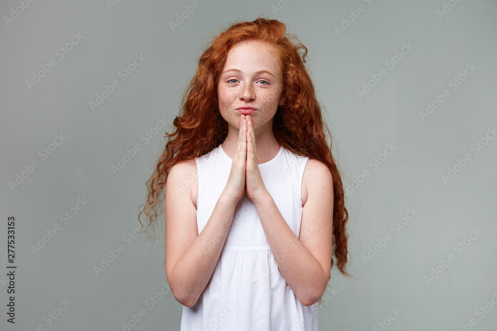 Portrait of beging nice little girl with ginger hair and freckles ...