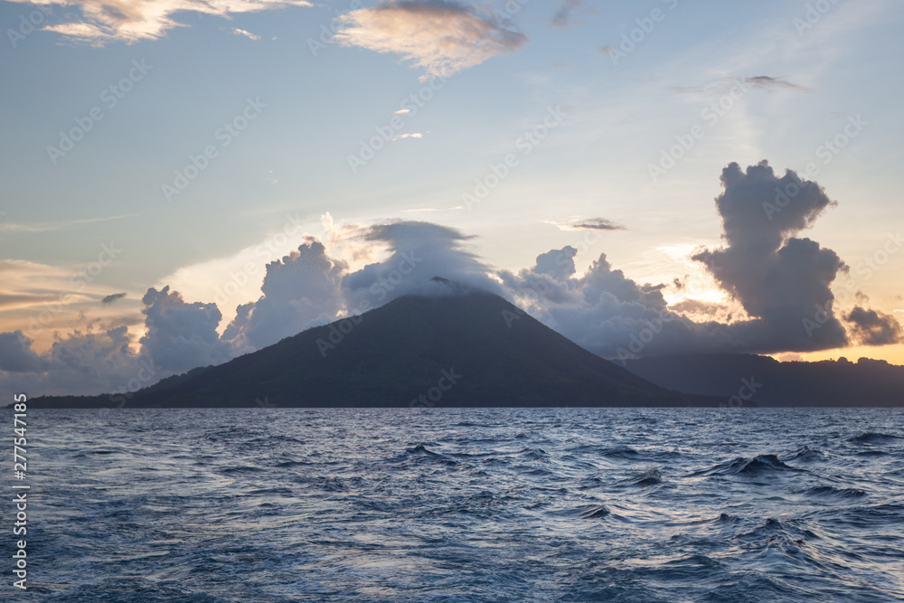 The majestic volcano of Gunung Api rises from the seascape in the Banda ...