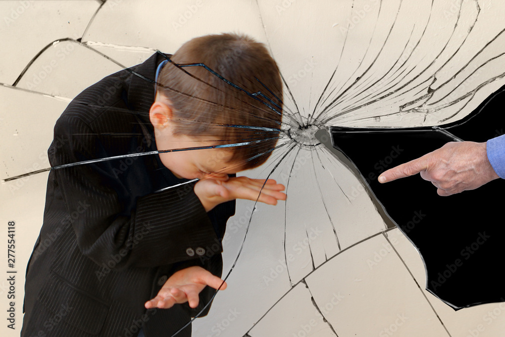 reflection in shards of a broken mirror, a crying boy, a junior ...