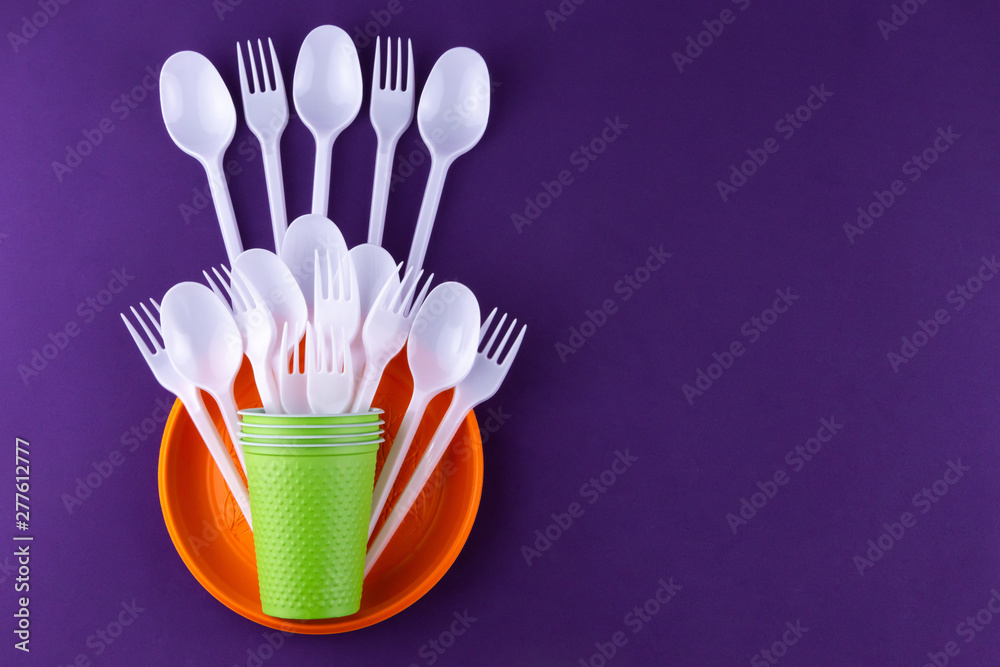 Single-use plastic objects, ecological pollution. Plastic waste. Orange ...