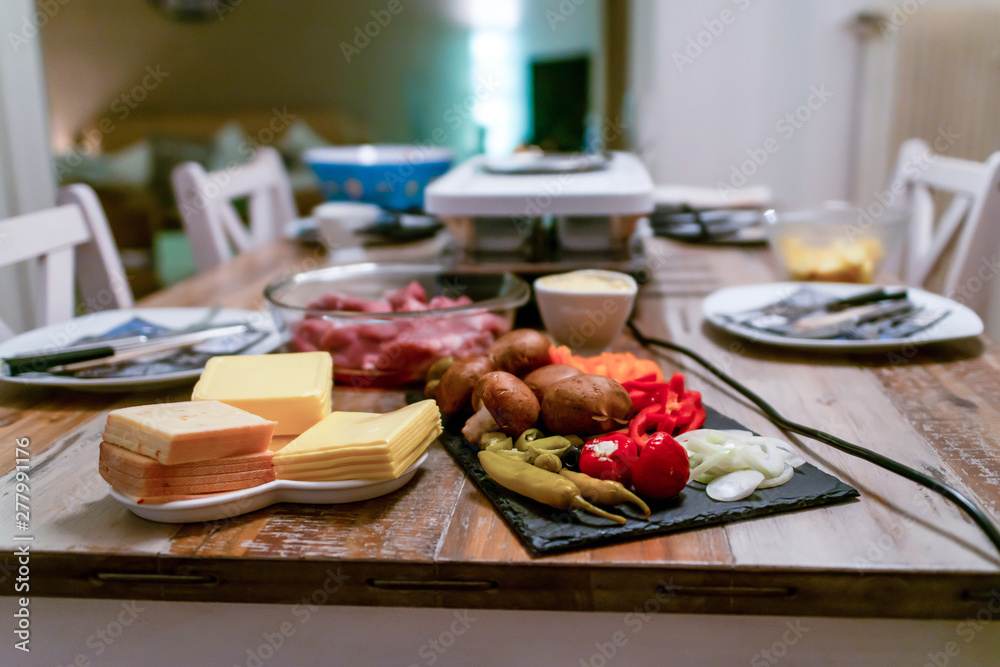 Swiss or Dutch raclette table filled with ingredients for a celebratory ...
