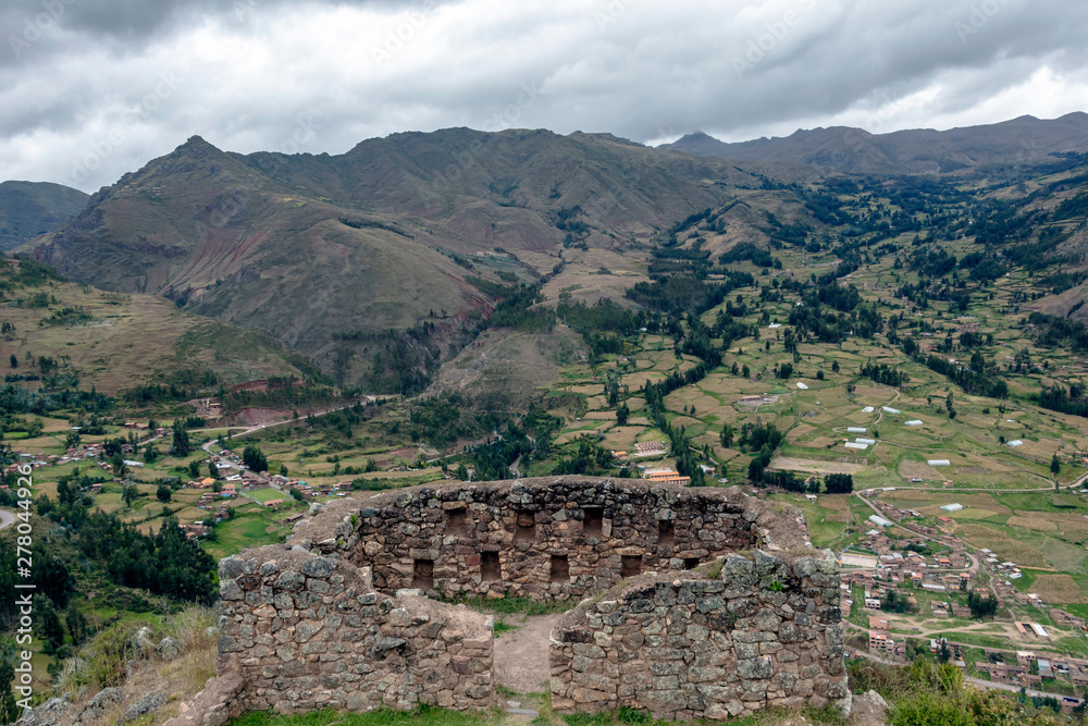 Inca ruins in Pisac archeological site and green peruvian Andes ...