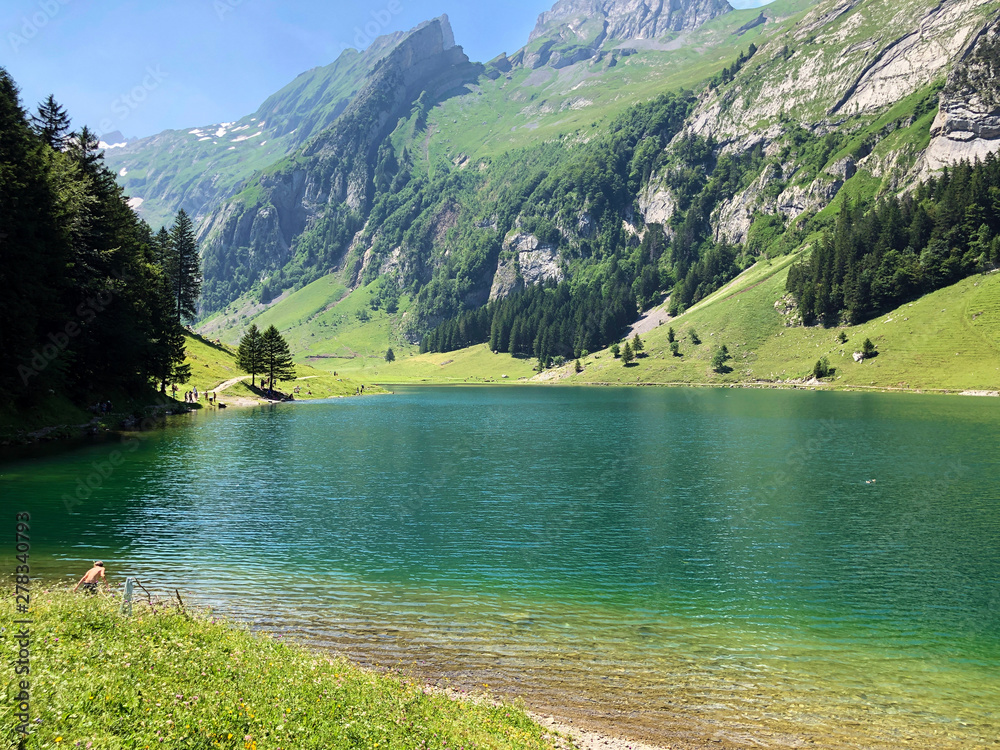 Alpine lake Seealpsee in the Alpstein mountain range and in the ...
