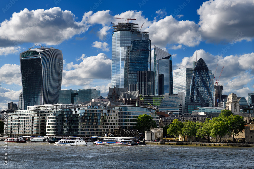 Tower Pier with tour boats on the River Thames financial district ...