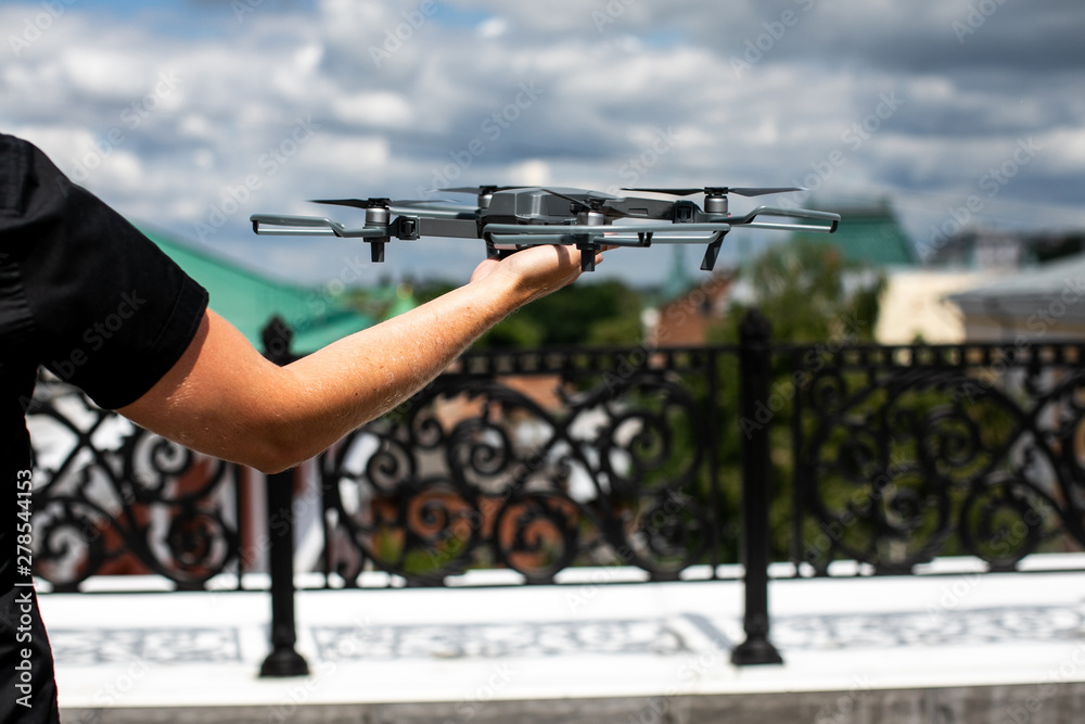 Drone landing on hand. Drone and photographer man hands.drone copter ...