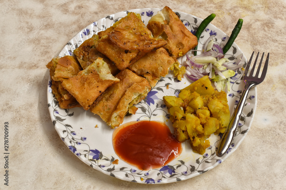 Mughlai paratha, a popular fast food in India, served with potato curry ...