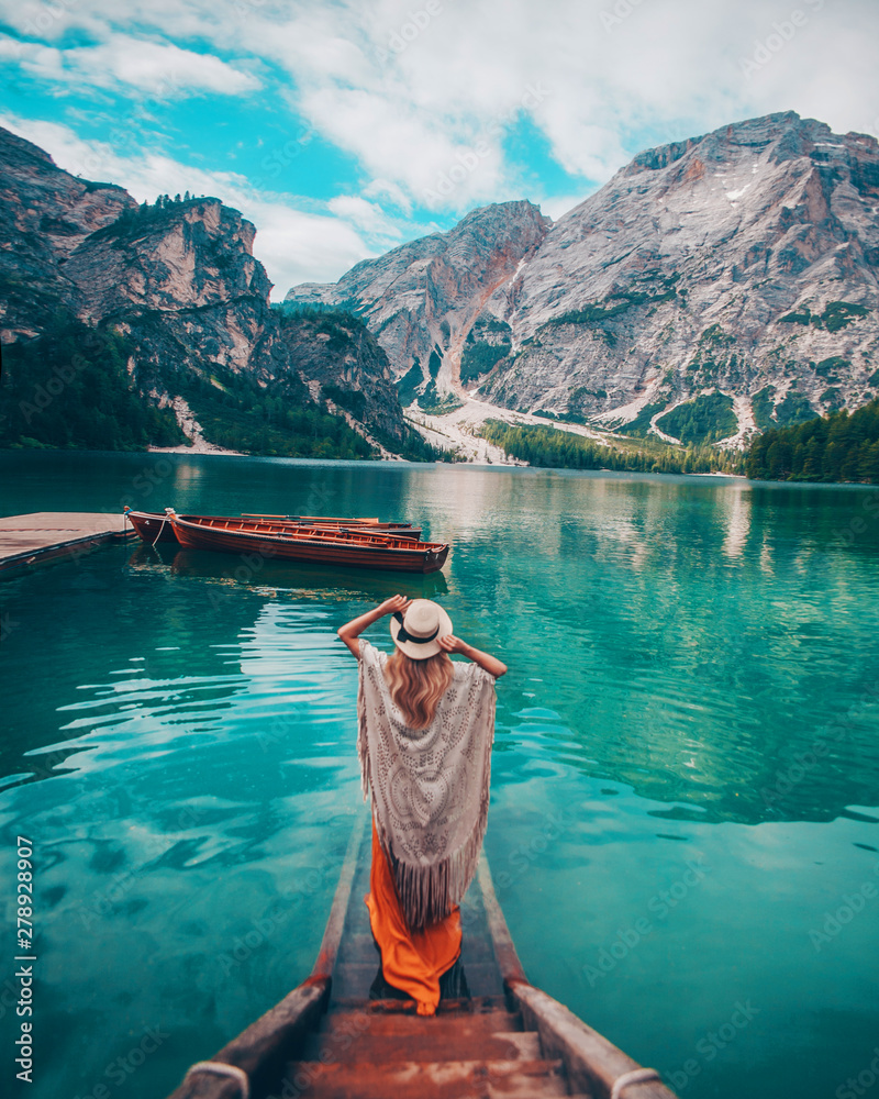Girl in a hat on the background of the turquoise lake in mountain ...