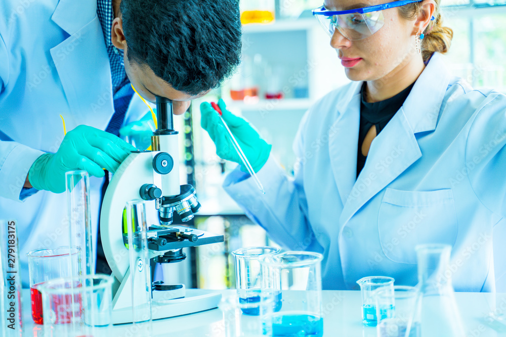 Two scientists conducting research in a lab environment.Analyze ...