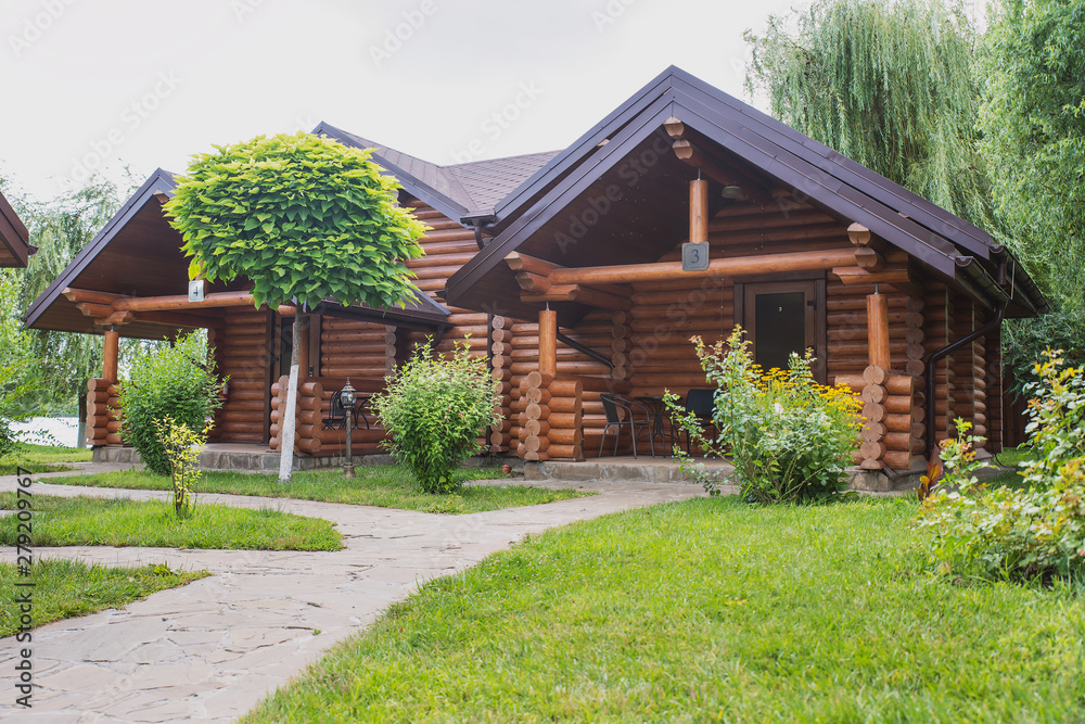 Country cottages with log and timber in the green area. cozy eco ...