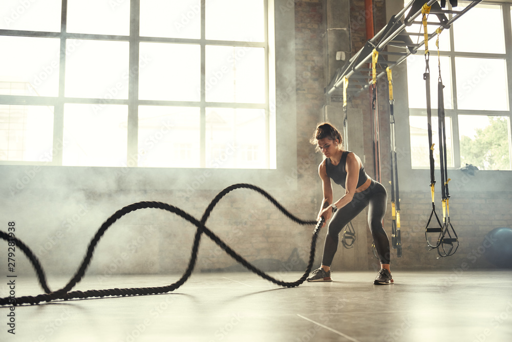 Strong and beautiful. Young athletic woman with perfect body doing ...
