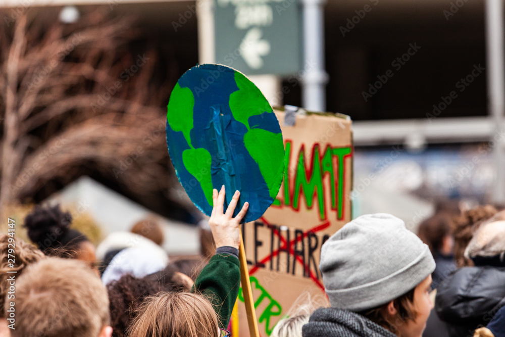 Homemade sign at environmental rally. A colorful placard depicting ...