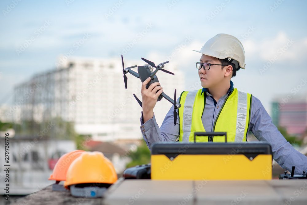 Asian engineer man working with drone and working tools at construction ...