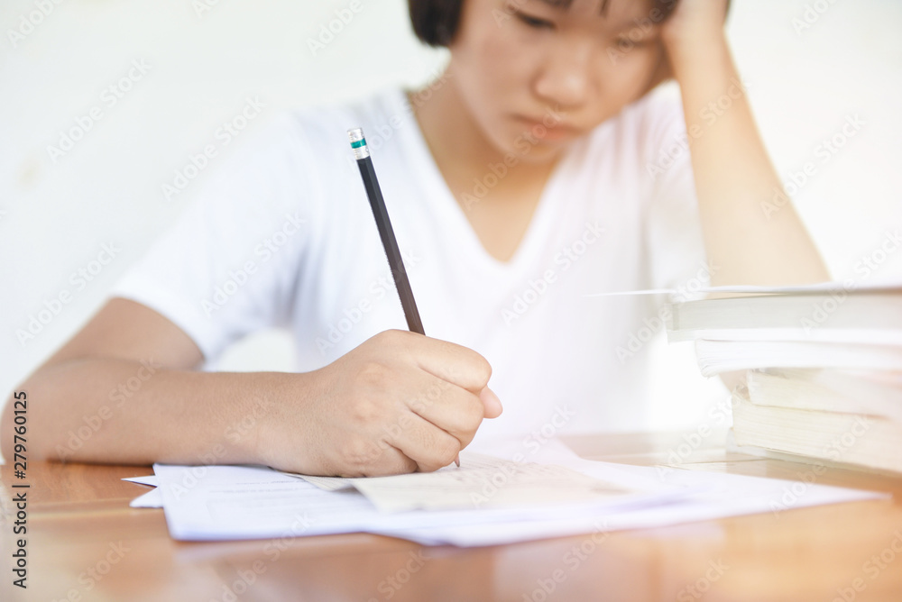 exam stress / education young female college in class taking notes and ...