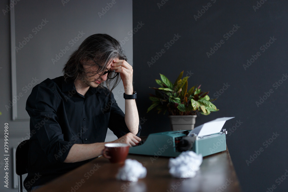 Young writer with a typewriter. Young writer pensive in front of her ...