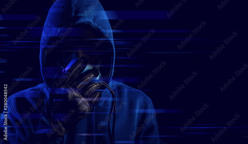 hacker man hood outfit mask with glove on dark background in security ...