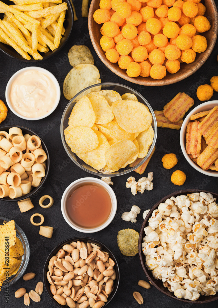 All classic potato snacks with peanuts, popcorn and onion rings and ...