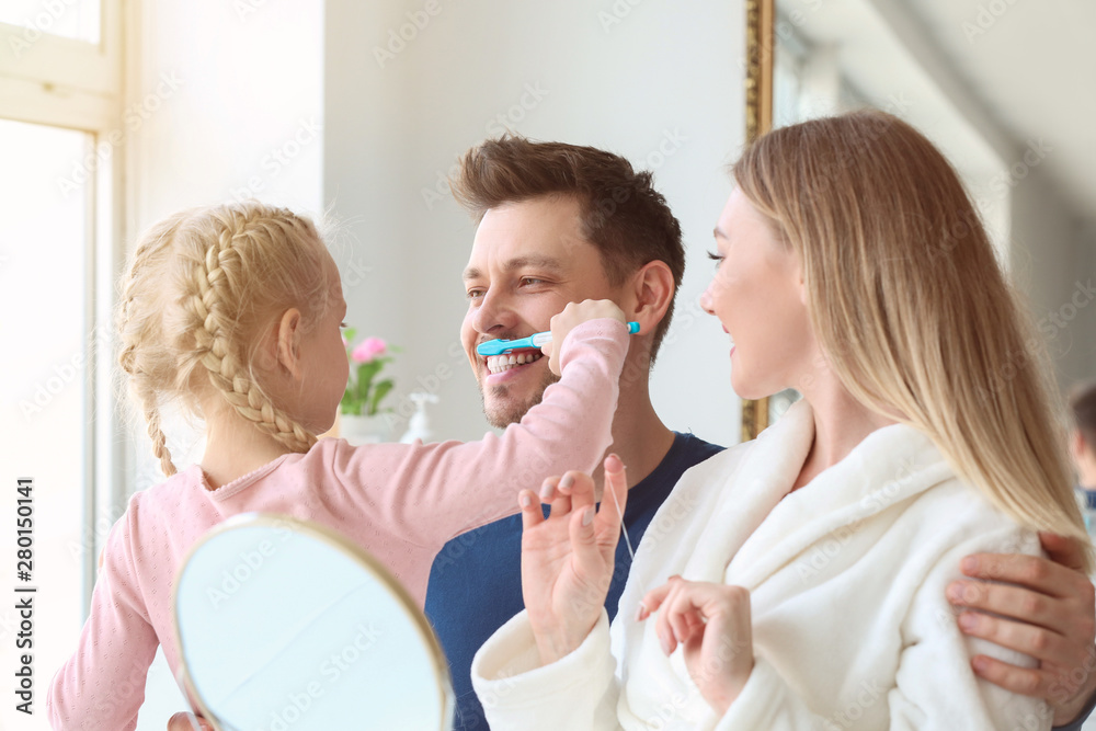 Family cleaning teeth at home Stock Photo | Adobe Stock
