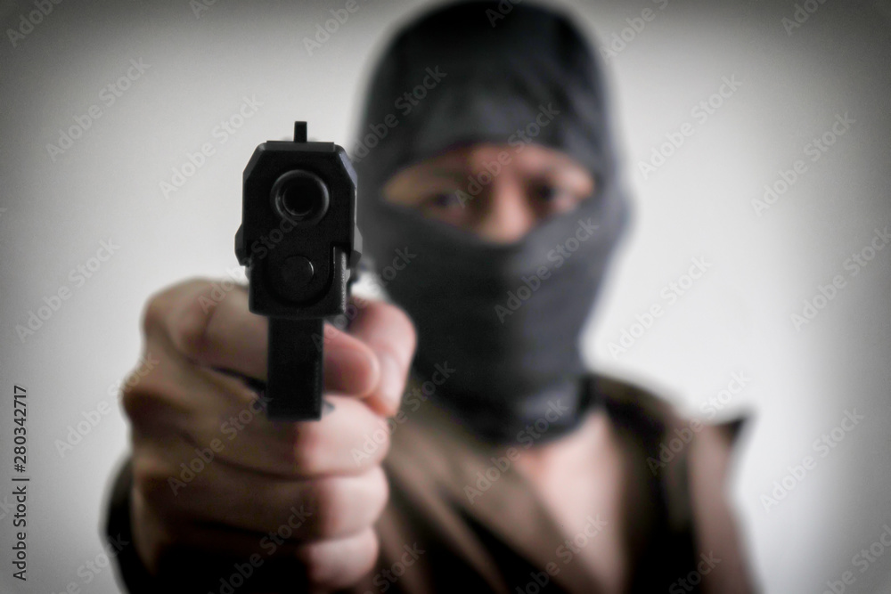 Gunman aiming his target.terrorism shoots a pistrol handgun.Criminal ...