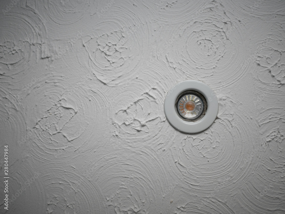 LED downlight in swirly patterned ceiling plaster pattern known as ...
