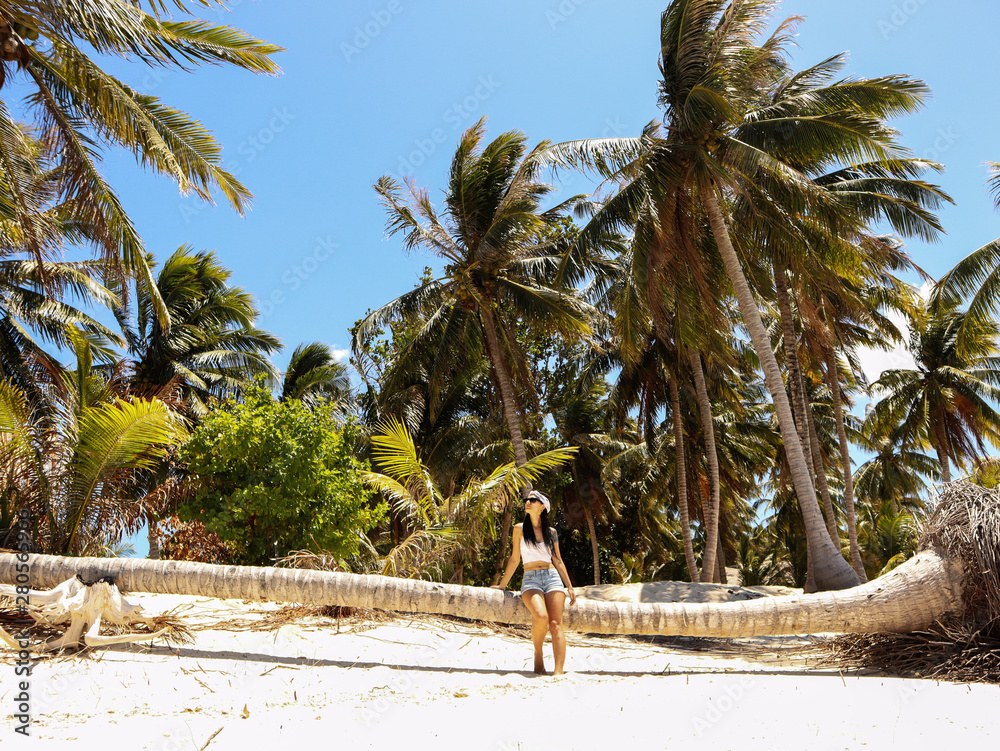 Foto de Stock girl sitting on palm tree body like a bench in Onok ...