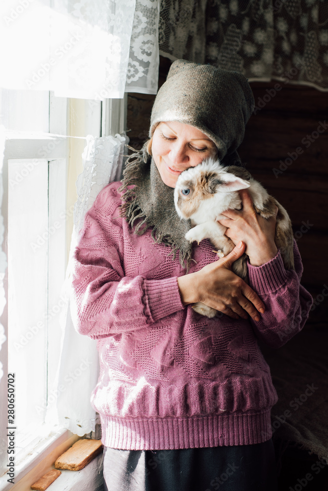 Beautiful woman hugging rabbit Stock Photo | Adobe Stock