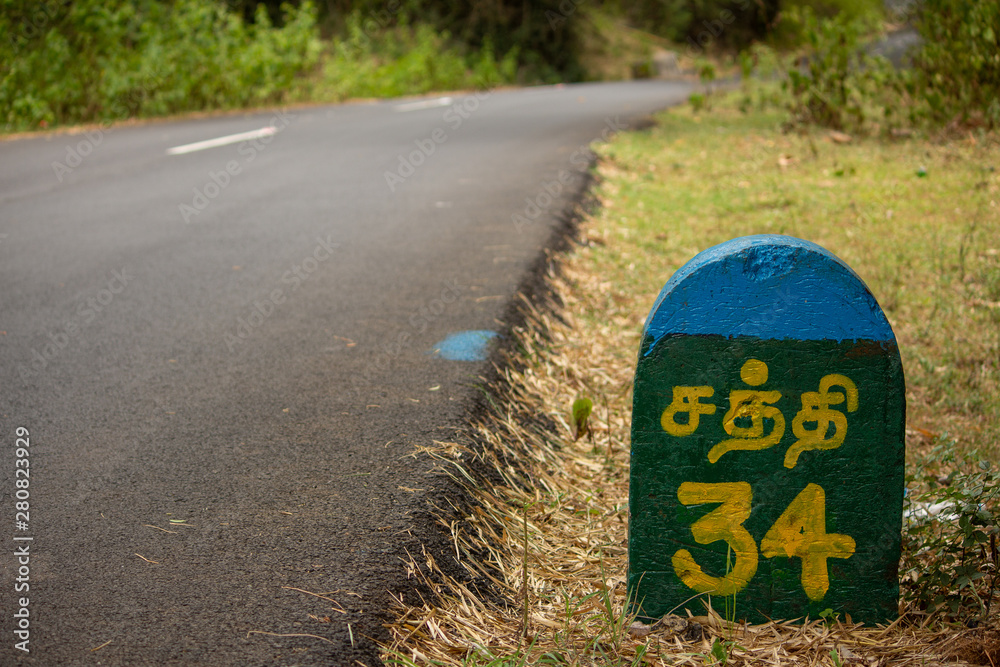 Photo Stock Beautiful Ghat road with Milestone indicating distance to Sathyamangalam (in tamil ...