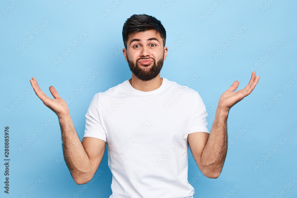 Clueless puzzled handsome guy having hesitation, shrugging his ...
