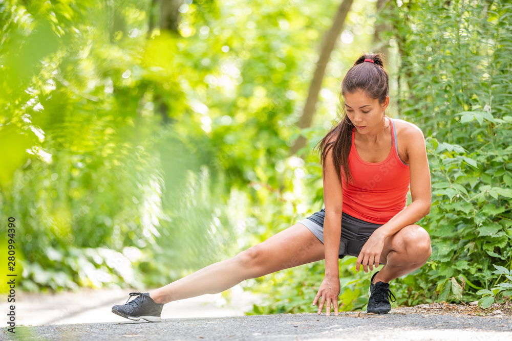 Runner woman stretching leg running workout run girl doing legs ...